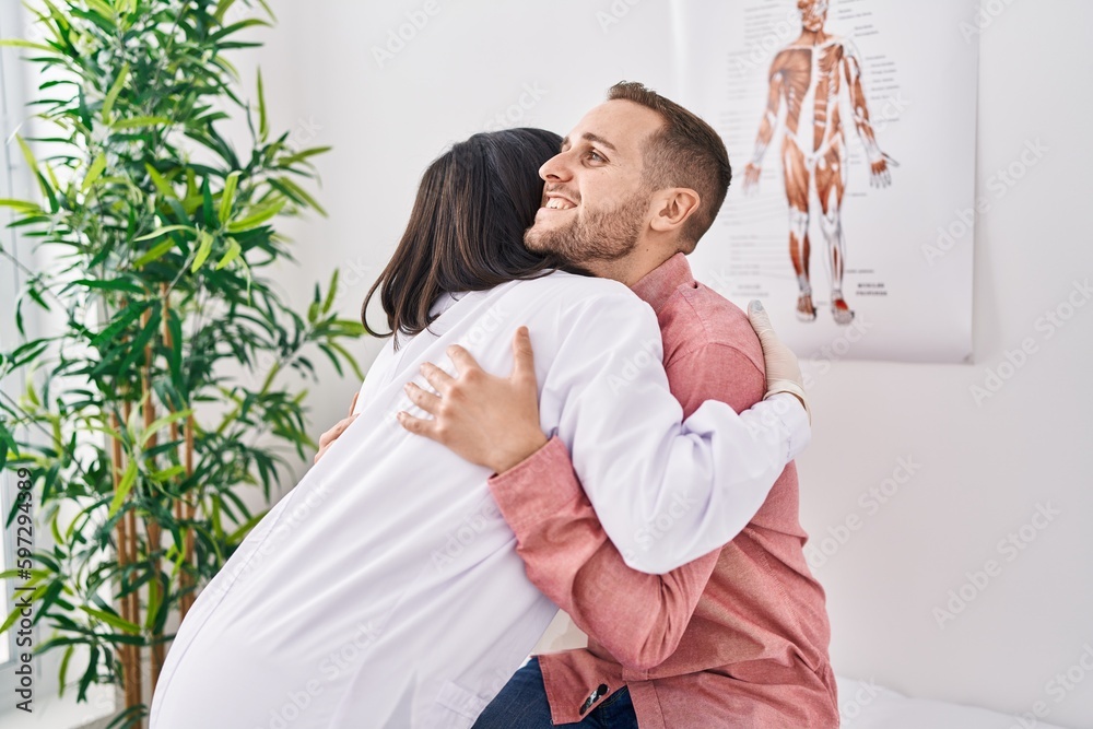 Man and woman doctor and patient hugging each other at clinic Stock ...