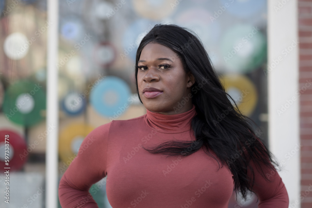 Wearing a sleek, long-sleeved turtleneck, a model expresses a colorful ...