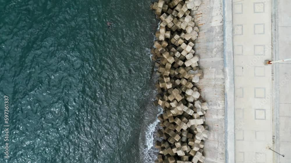 Top Down Aerial View of Concrete Tetrapods lined up against Philippine ...