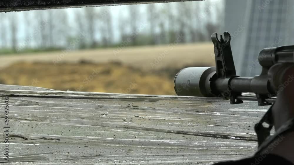 The muzzle of the machine gun looks out the window of the loophole ...