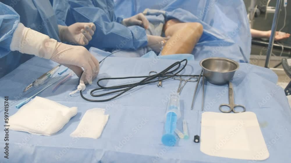 Surgical operation on the leg for varicose veins. A surgeon performs an ...
