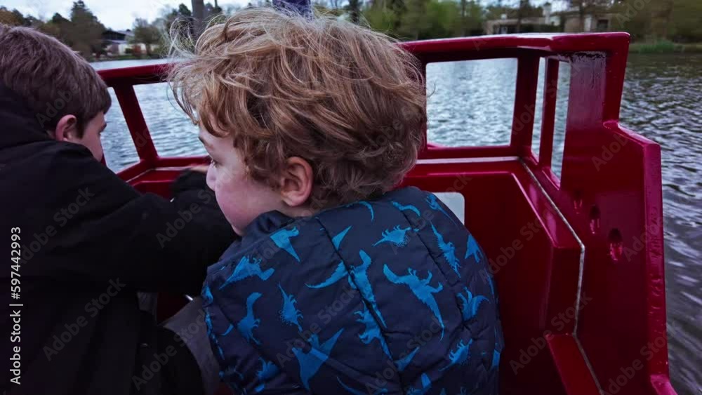 Happy children at the helm of boat ship on lake. Little captain at ...
