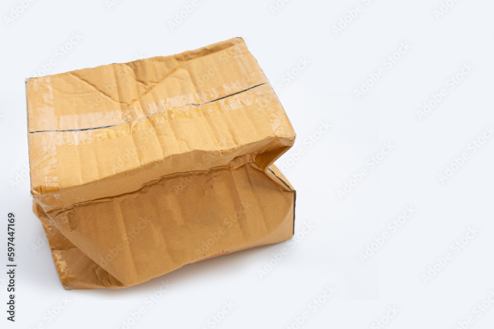 Damaged cardboard box on white background. Stock Photo | Adobe Stock