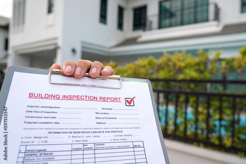 The foreman is review on building inspection report form to QC building ...