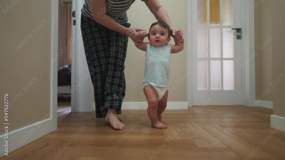 Video Stock baby takes the first steps to learn. happy family kid dream ...