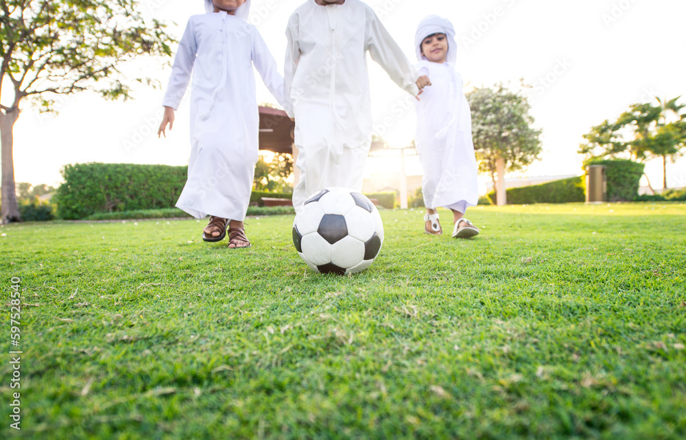 Children playing together in Dubai in the park. Group of kids wearing ...