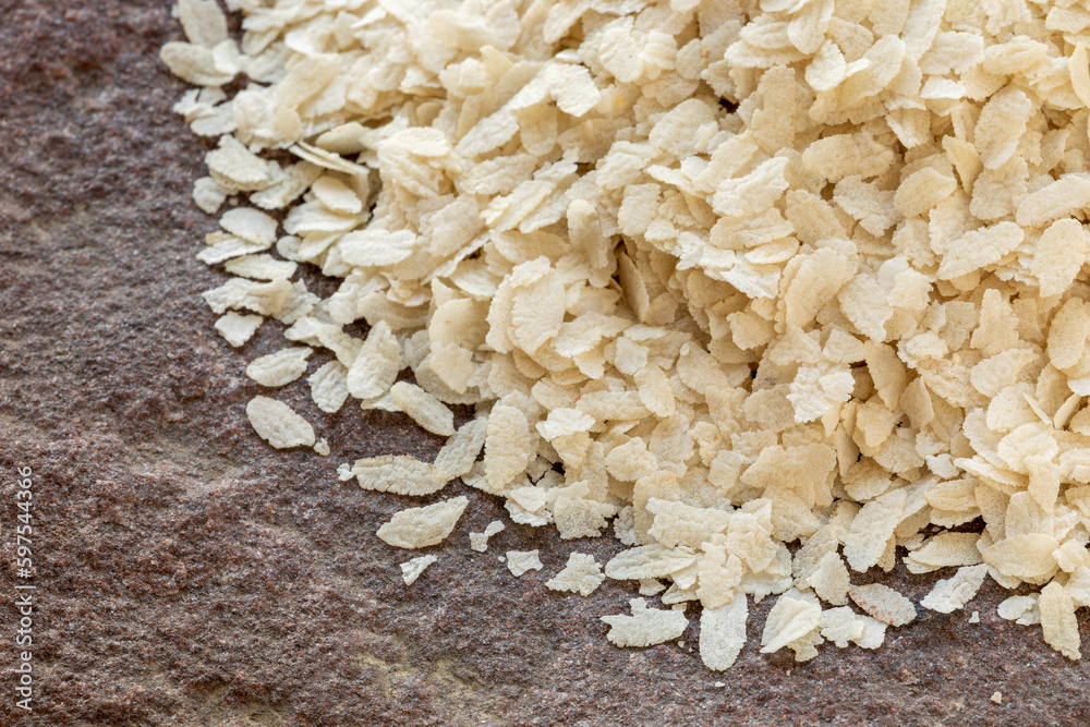 Poha, flattened rice on stone surface. Basis for Indian breakfast or ...