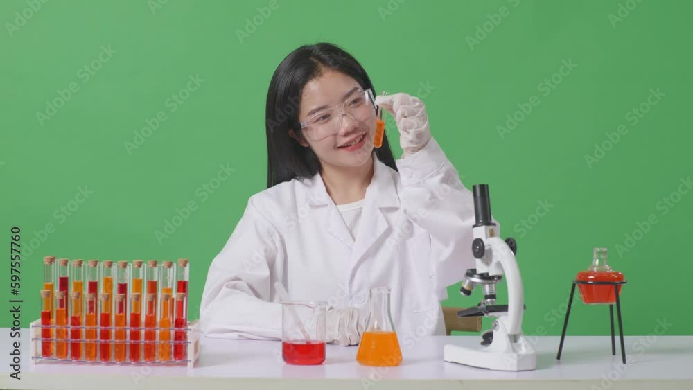 Side View Of Asian Woman Scientist Looking Through A Microscope On The ...