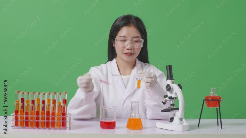 Side View Of Asian Woman Scientist Looking Through A Microscope On The ...