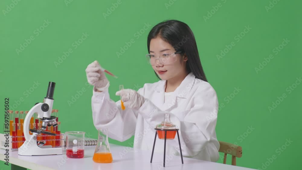 Side View Of Asian Woman Scientist Looking Through A Microscope On The ...