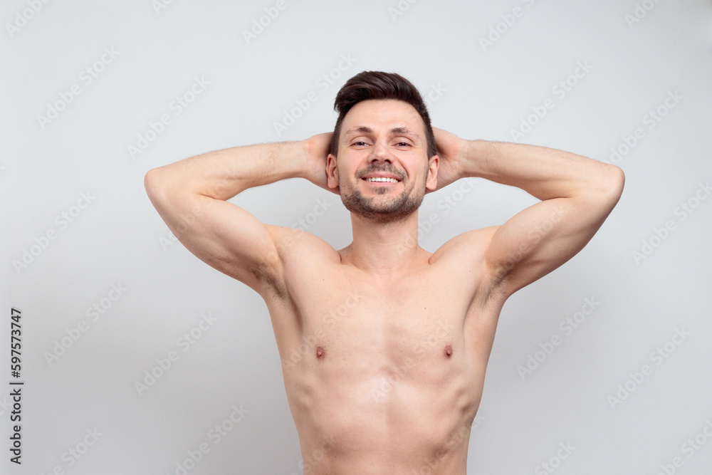 Attractive smiling young man isolated on gray background. Having two ...