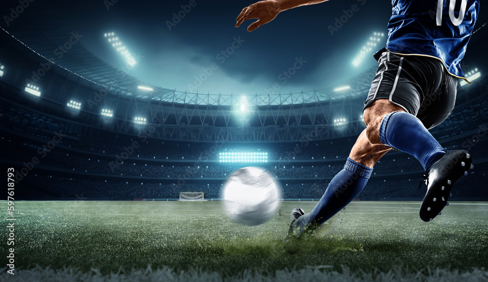 football soccer player kicking football in blue team night stadium ...