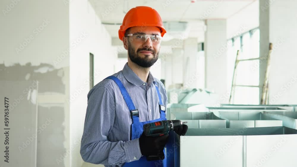 Portrait of hvac worker with ventilation pipes on construction site ...