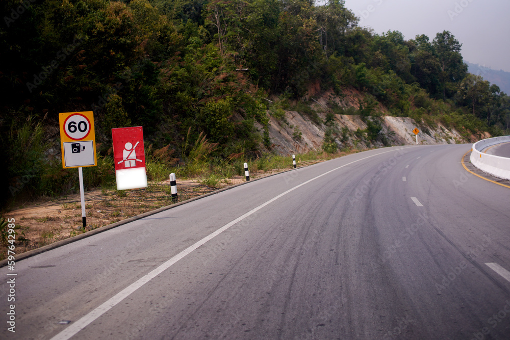 Speed limit warning sign on highway, and speed cameras for road safety ...