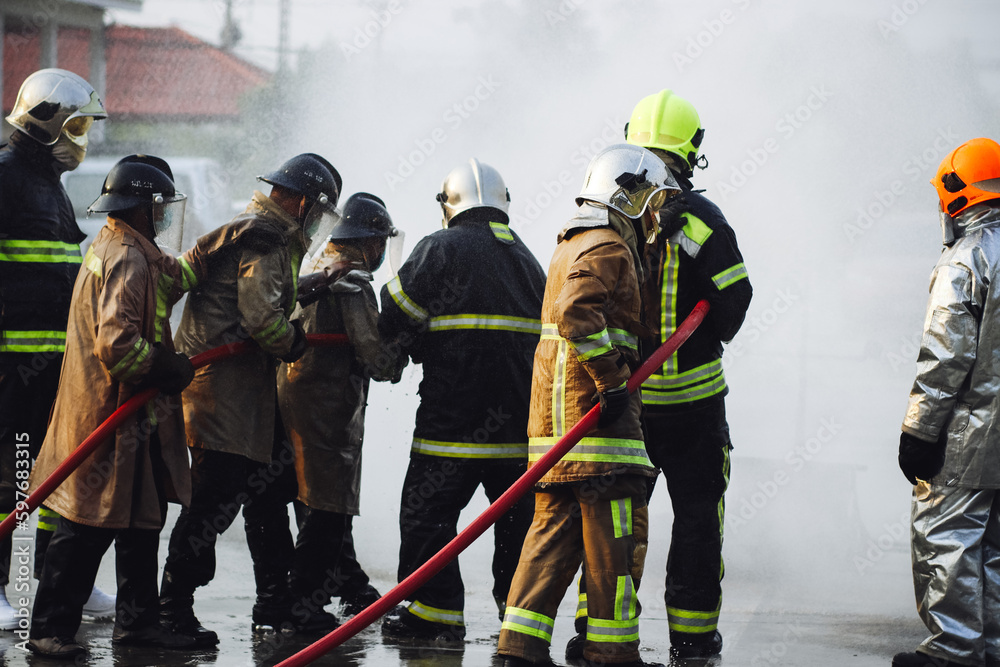 Firefighters using Twirl water fog type fire extinguisher to fighting ...
