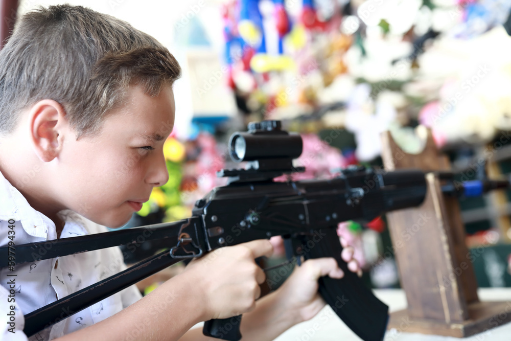 Child shoots air rifle Stock Photo | Adobe Stock