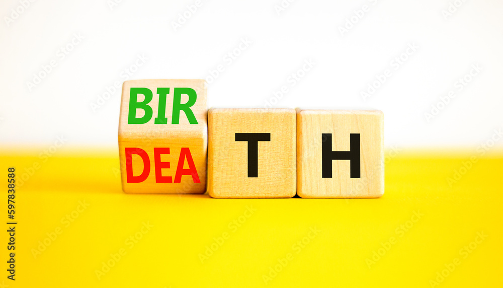 Birth or death symbol. Businessman turns wooden cubes and changes the ...