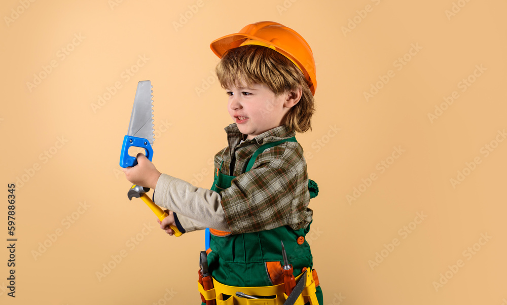 Little repairman with saw and hammer. Child repairman playing with toy ...