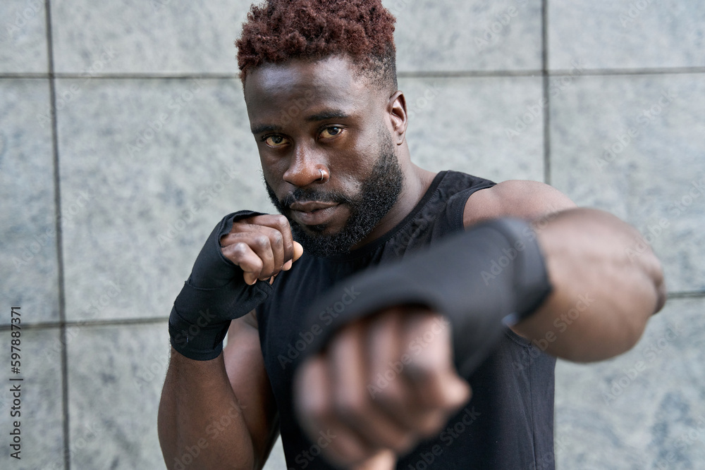 Strong confident young black man boxer fighter standing outdoors ...