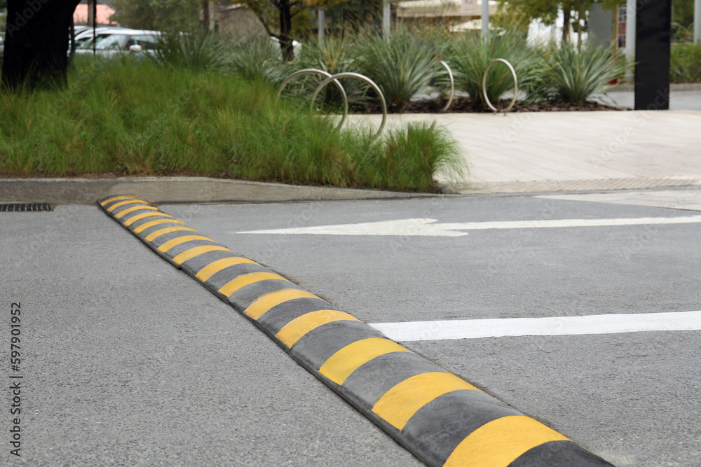 Striped speed bump on street. Road safety Stock Photo | Adobe Stock