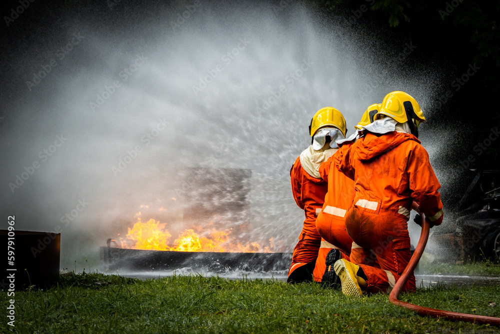 Firefighter Concept. Fireman using water and extinguisher to fighting ...