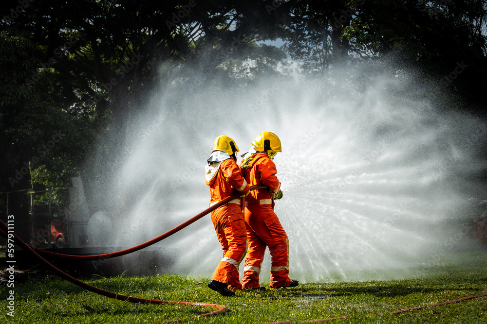 Firefighter Concept. Fireman using water and extinguisher to fighting ...