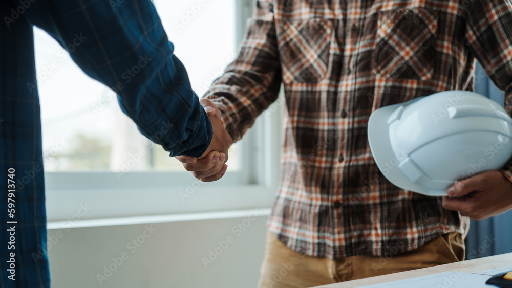 Shaking hands, Civil engineer teams meeting house rebuilding foundation ...
