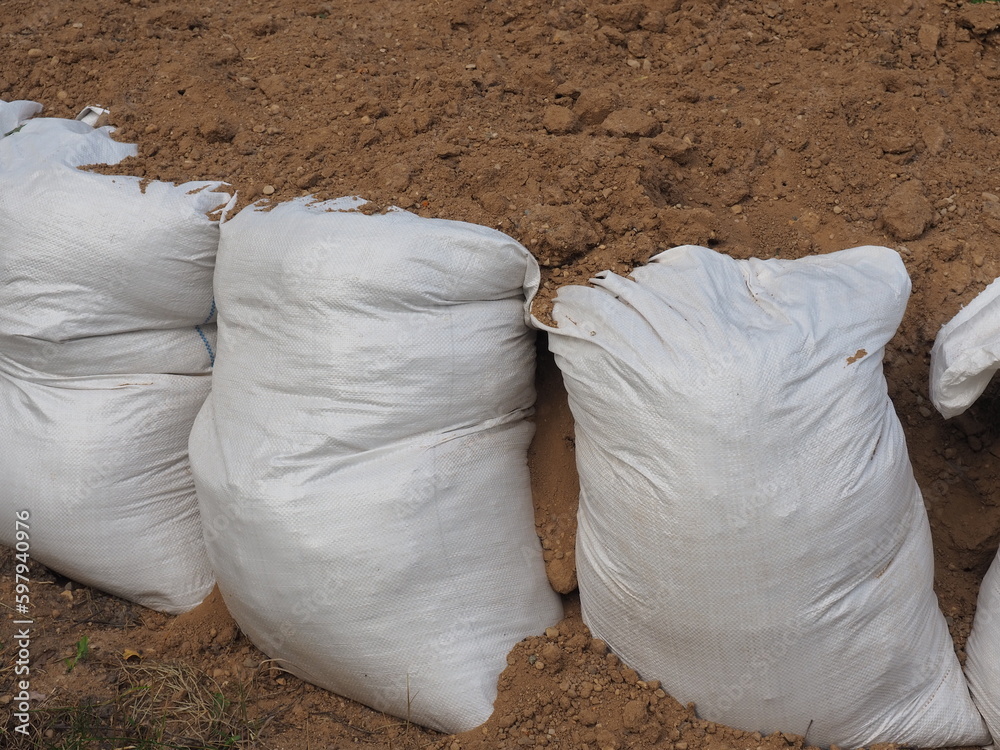Foto de Sand pile and sandbags. A barricade wall made of sandbags ...