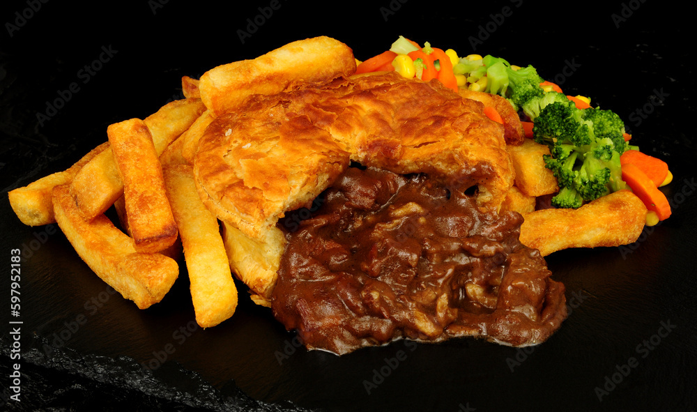 Foto de Steak and gravy puff pastry pie and chips meal with mixed ...