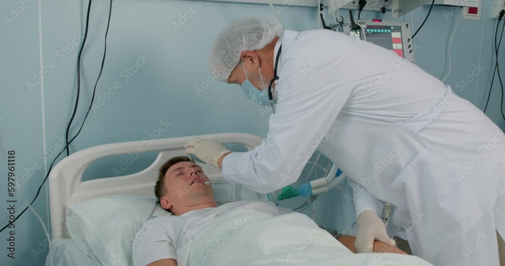 old senior doctor checking pupillary response of week young sick ...