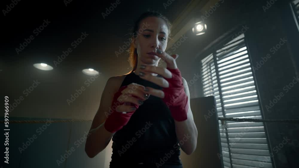 Woman fighter boxer wraps hands with boxing bandage. Kickboxing ...