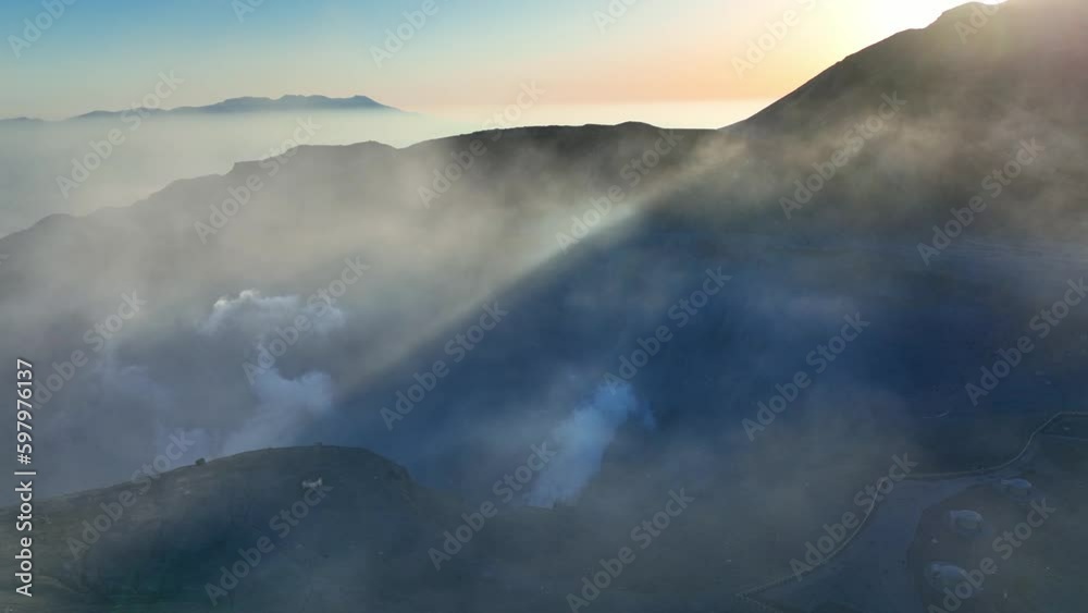 Smoke rising from the crater of active volcano in Japan, aerial view of ...