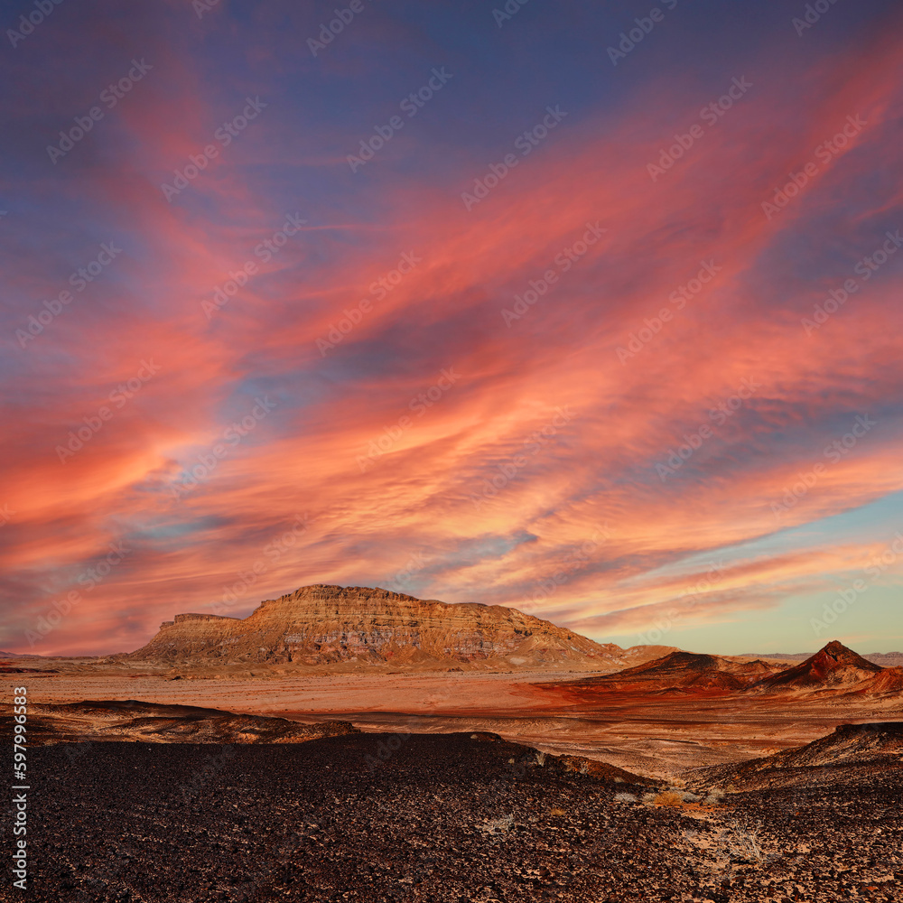 Sunrise over rocky desert and distant mountains in the wild. Wonderful ...