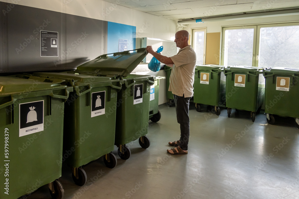 Stockholm, Sweden A man throws garbage in a super clean and organised ...