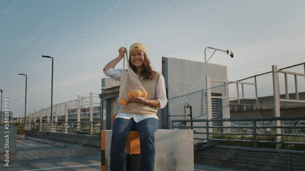 Young Gen Z woman asia people smile look at camera showing carry fruit ...