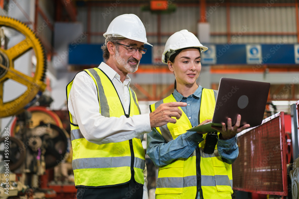 The project manager and engineers are inspecting workpieces and ...