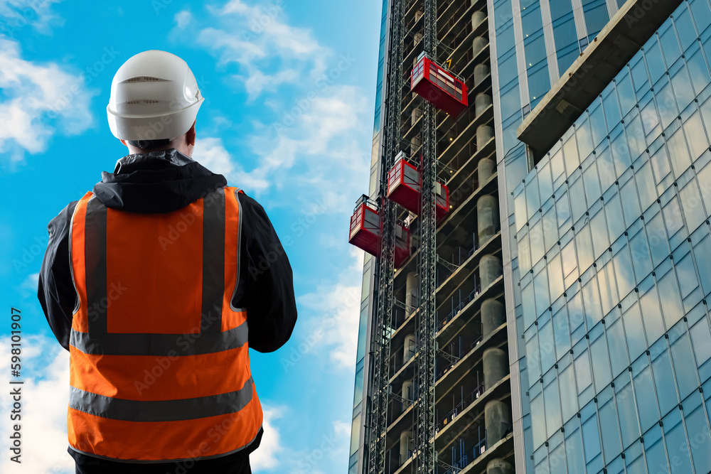 Construction company contractor. Man builder with his back to camera ...