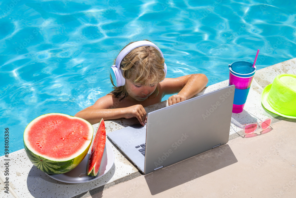Child work outside with laptop in pool. Kid working on laptop from the ...