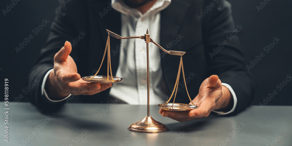 Lawyer or judge in formal black suit hold unbalanced scale with ...