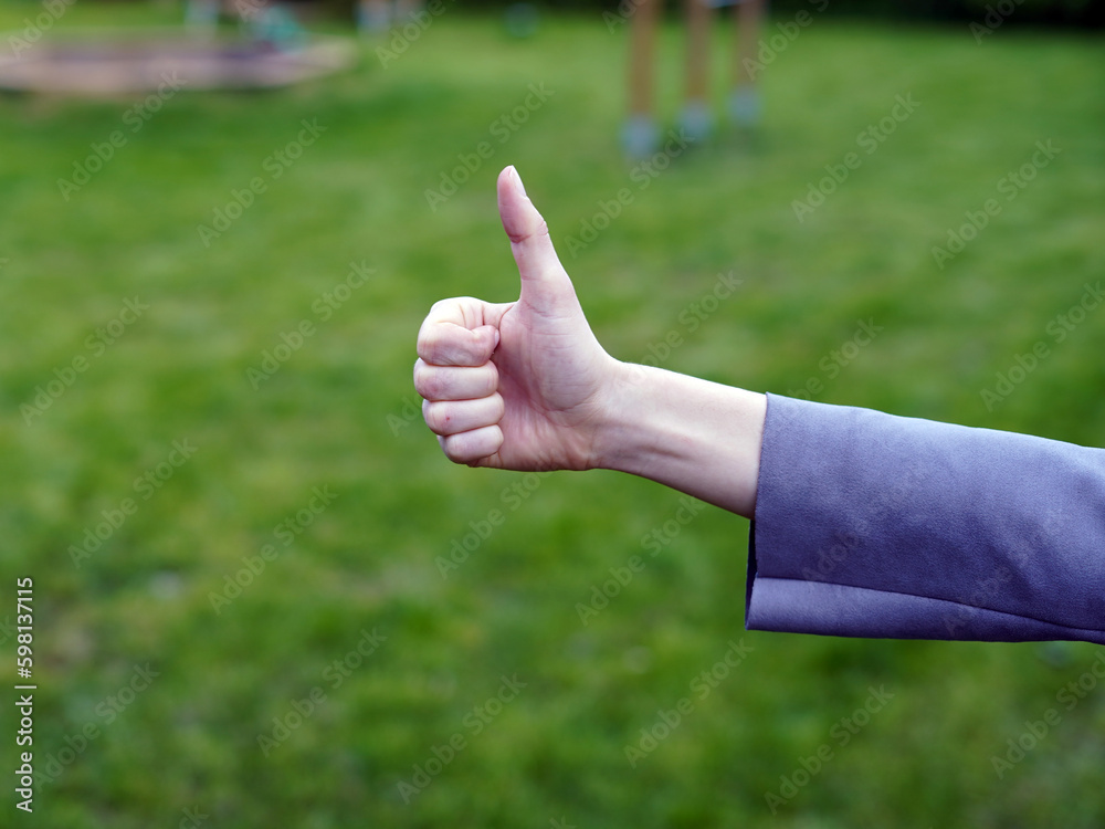 Hand gesture showing thumbs up. Stock Photo | Adobe Stock