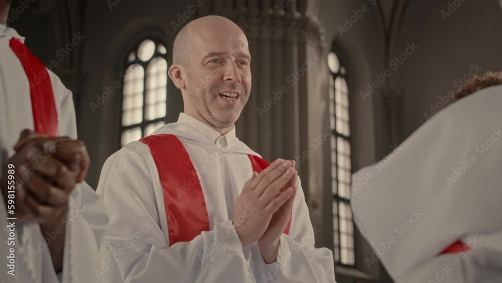 Middle aged bald headed Caucasian man and other members of church choir ...