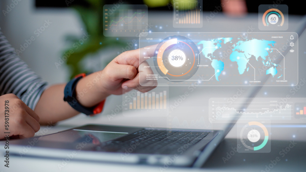 Data scientists. a programmer using a laptop to analyze and develop various information on a ...