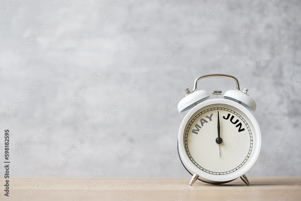 Hello June Changed from May month with vintage alarm clock on table ...