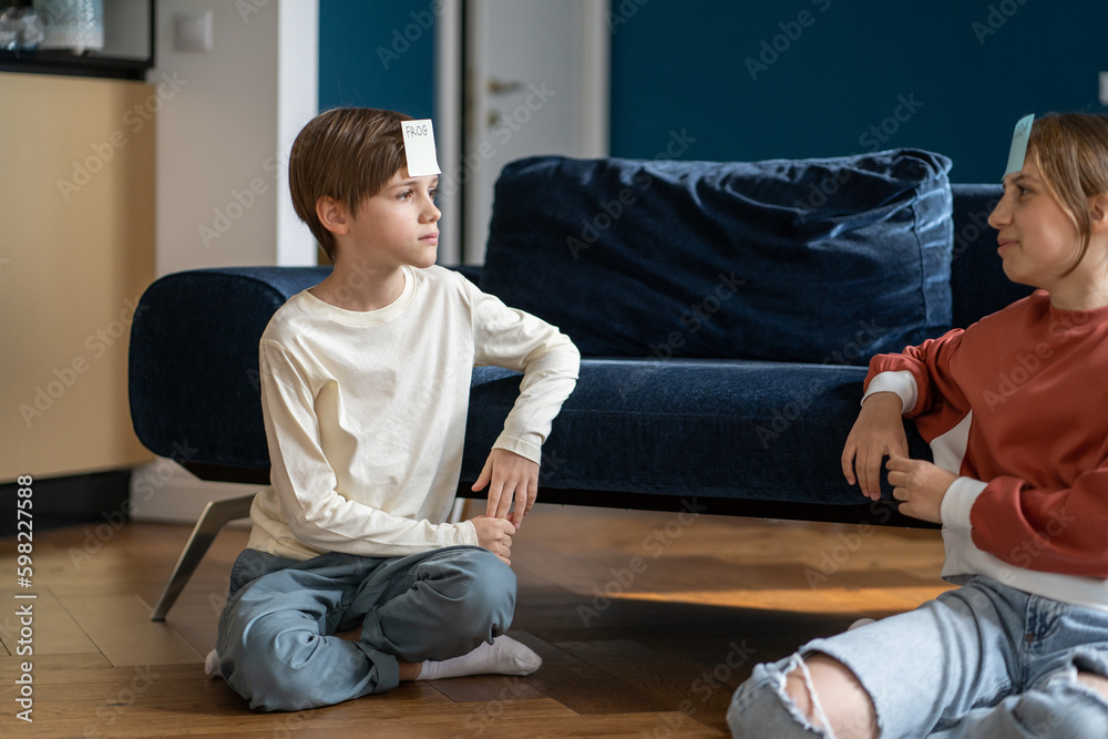 Guess who I am. Small children friends playing guessing game with ...