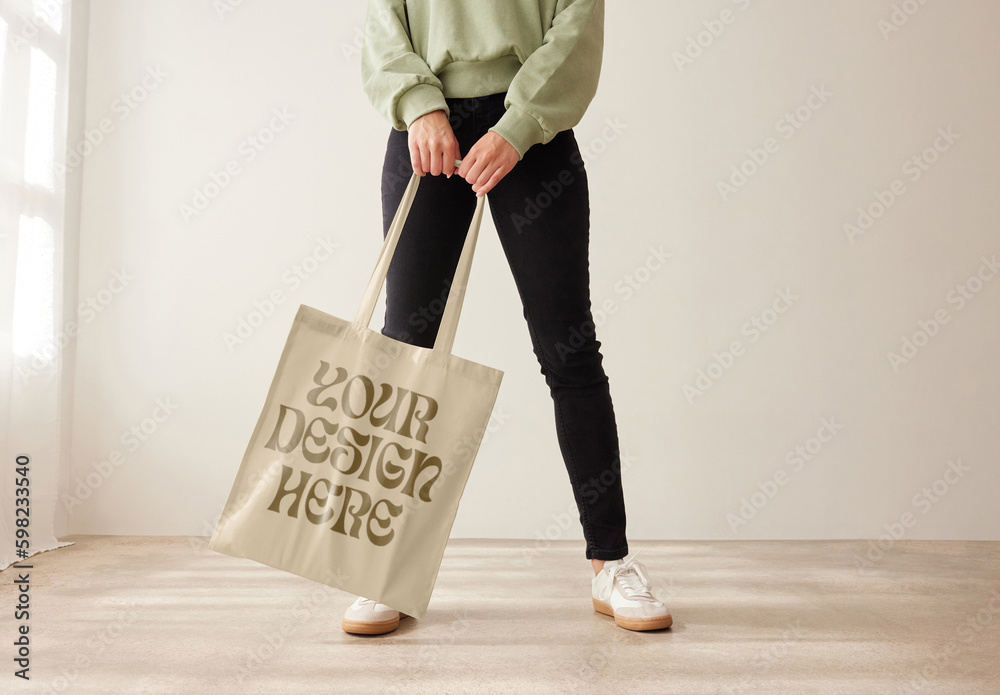Mockup of customizable tote bag being modelled by woman, front view low ...