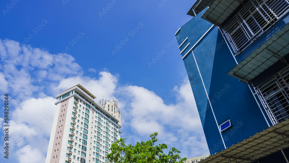 High-rise building photographed from below in the morning with clouds ...