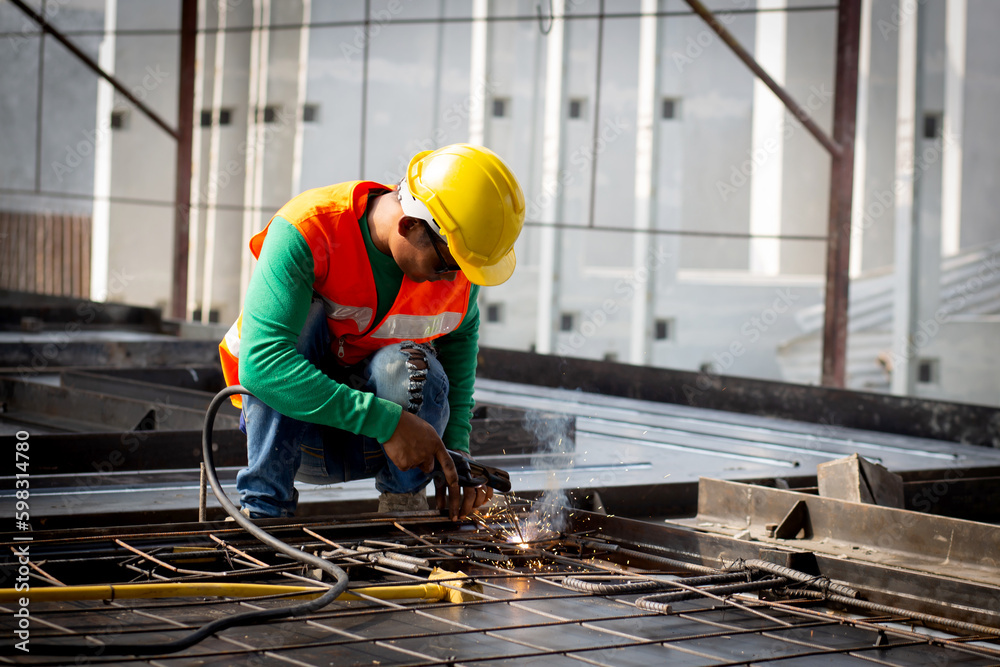 Young asian worker using machine welding iron with hands working in ...