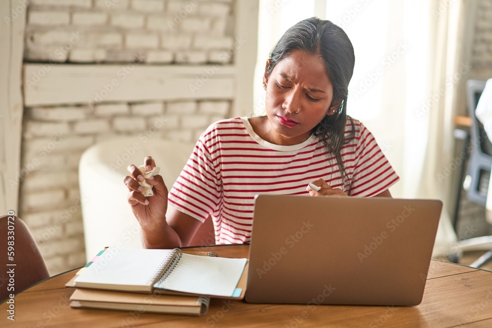Stressed student crumpling paper while doing university work. Stock ...