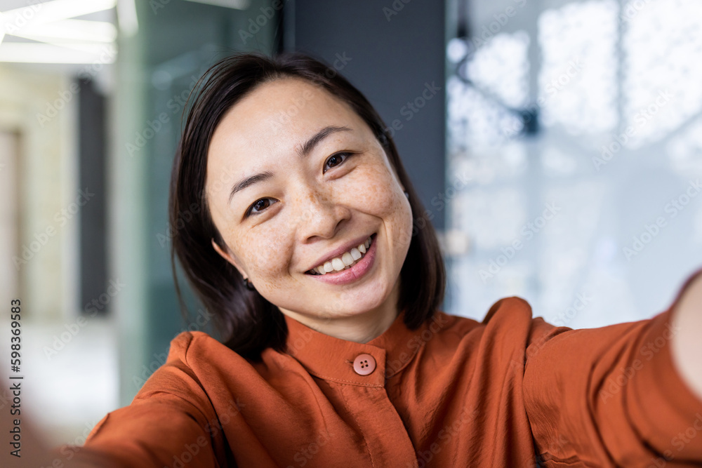 Young beautiful Asian business woman taking selfie photo, female worker ...