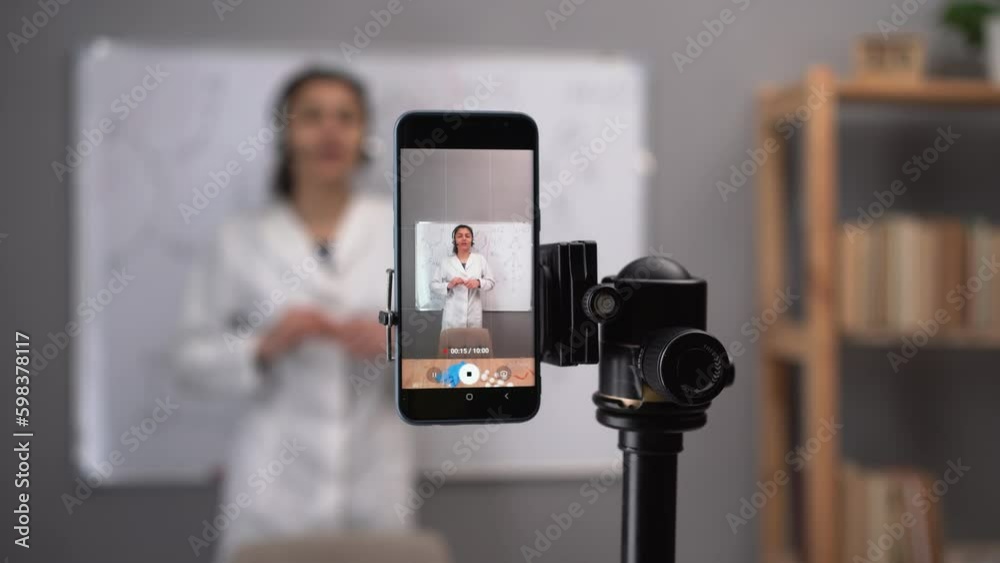 Smartphone records video lesson at school. An Italian young chemistry ...